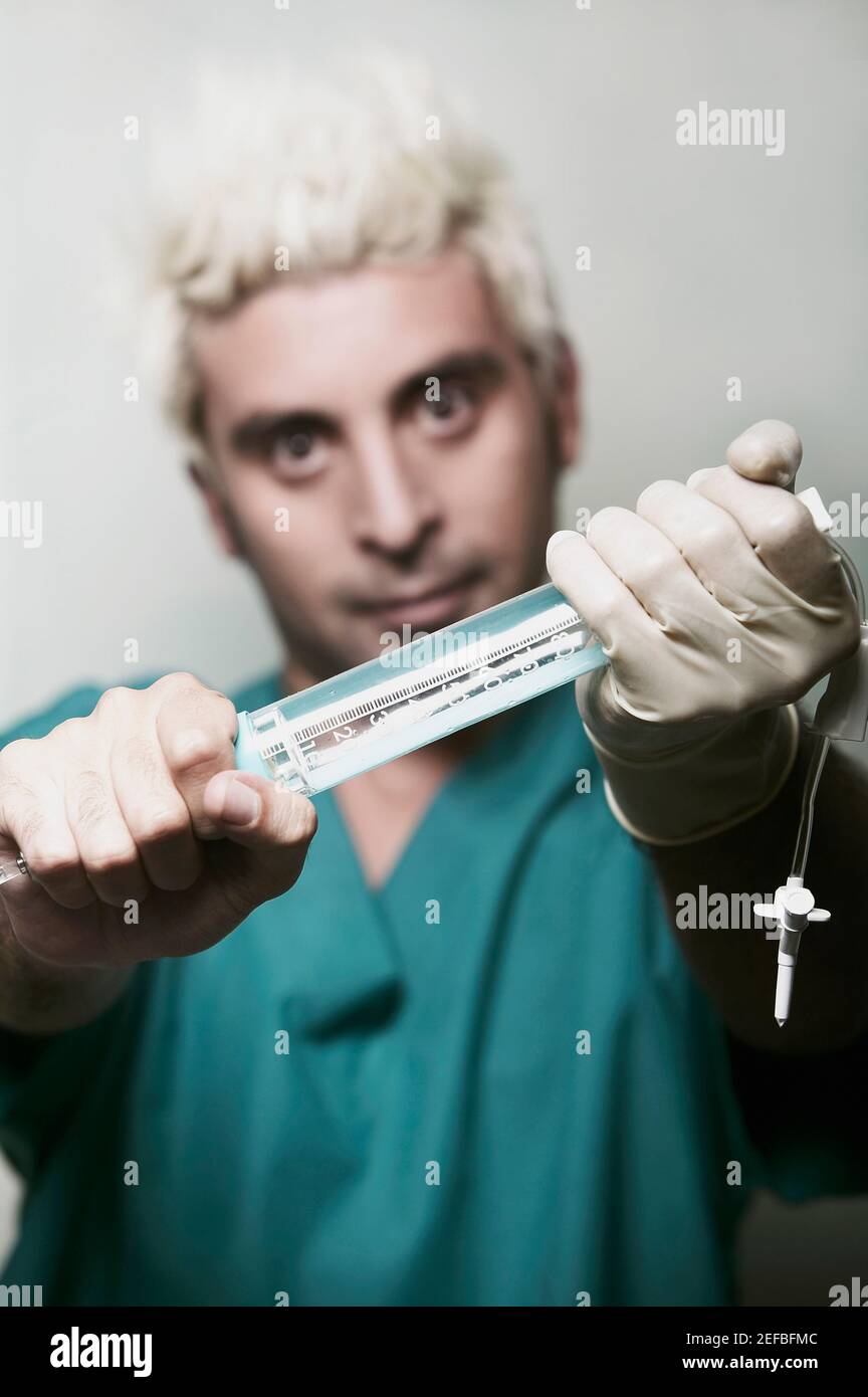 Portrait of a surgeon holding a syringe Stock Photo - Alamy