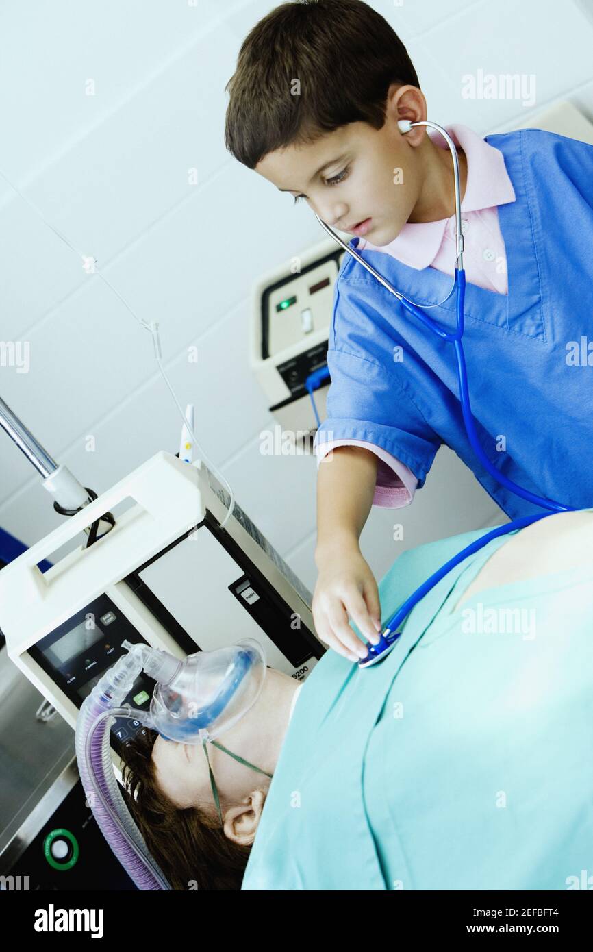 Boy imitating a doctor and examining a patient with a stethoscope Stock ...