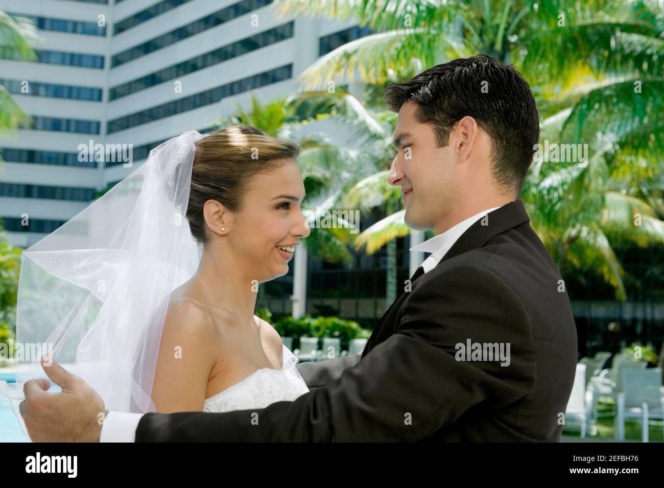 Side profile of a newlywed couple facing each other Stock Photo - Alamy
