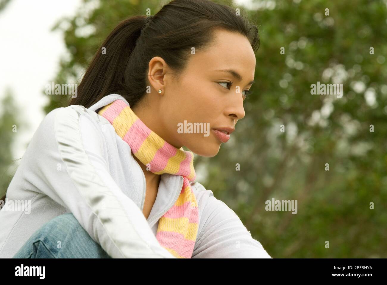 Low angle view of a young woman sitting Stock Photo - Alamy