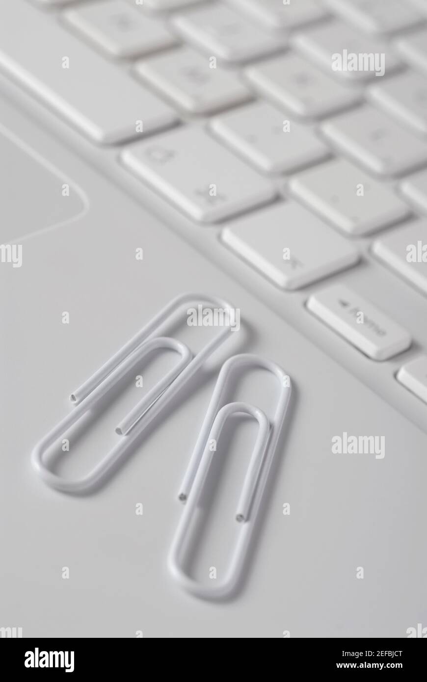 Close up of two paper clips on a laptop Stock Photo - Alamy