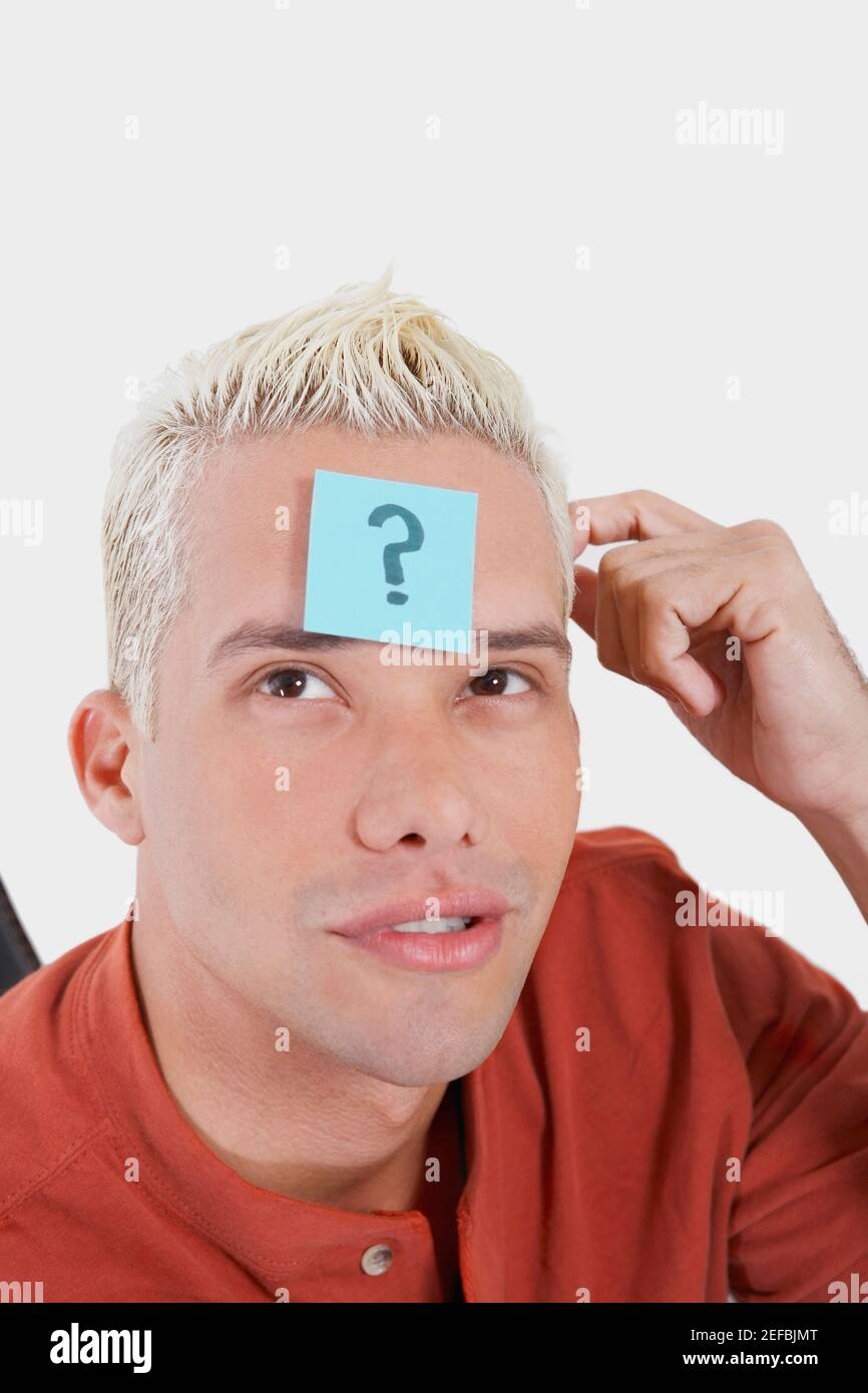 Close up of a young man with an adhesive note on his forehead Stock ...