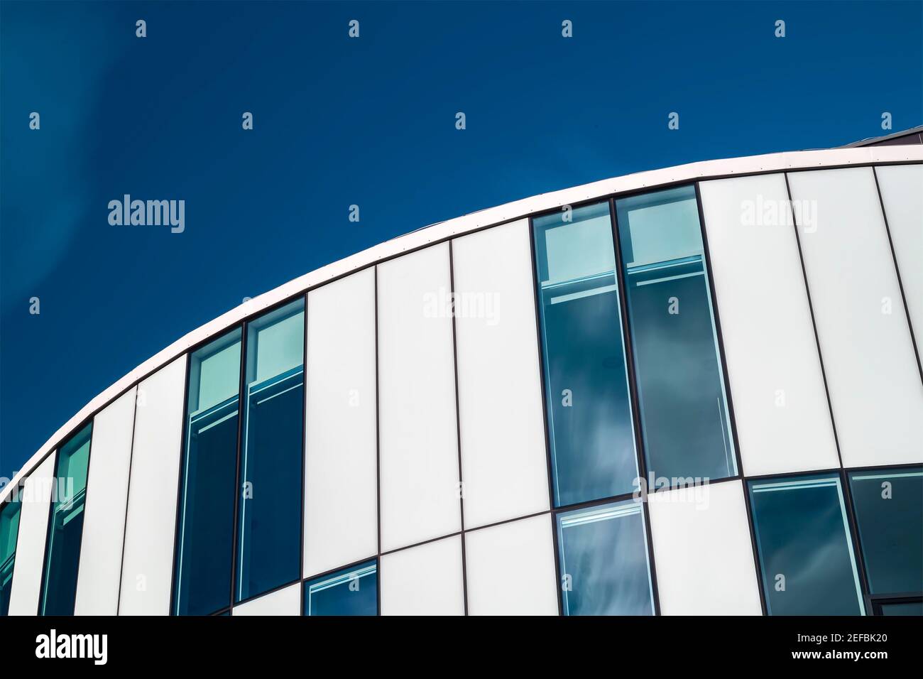 Detail of modern architecture with blue sky and window reflections ...