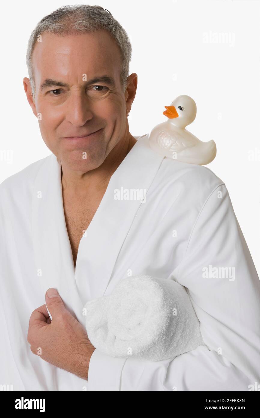 Portrait of a senior man holding a folded towel under his arm and ...