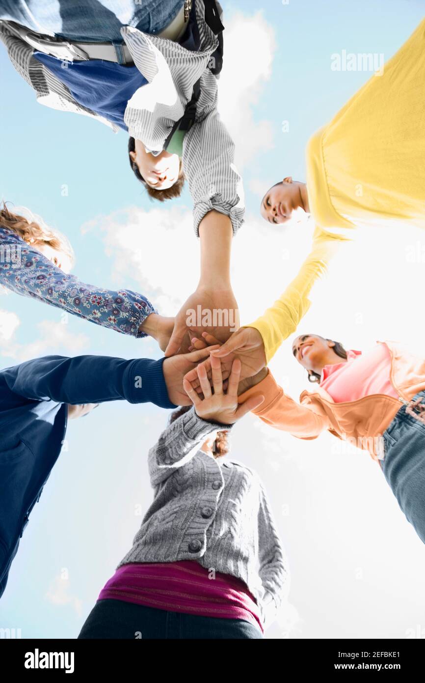 Low angle view of a group of friends smiling Stock Photo - Alamy
