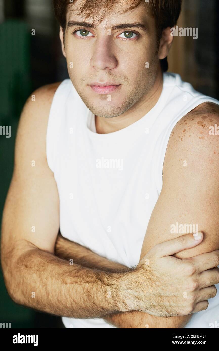Portrait of a young man with his arms crossed Stock Photo - Alamy