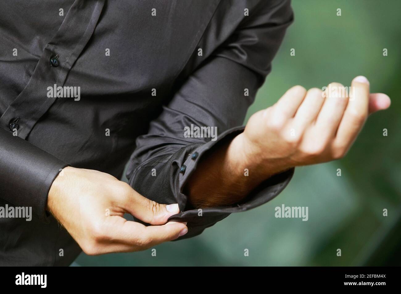 Mid section view of a man buttoning his cuff Stock Photo - Alamy