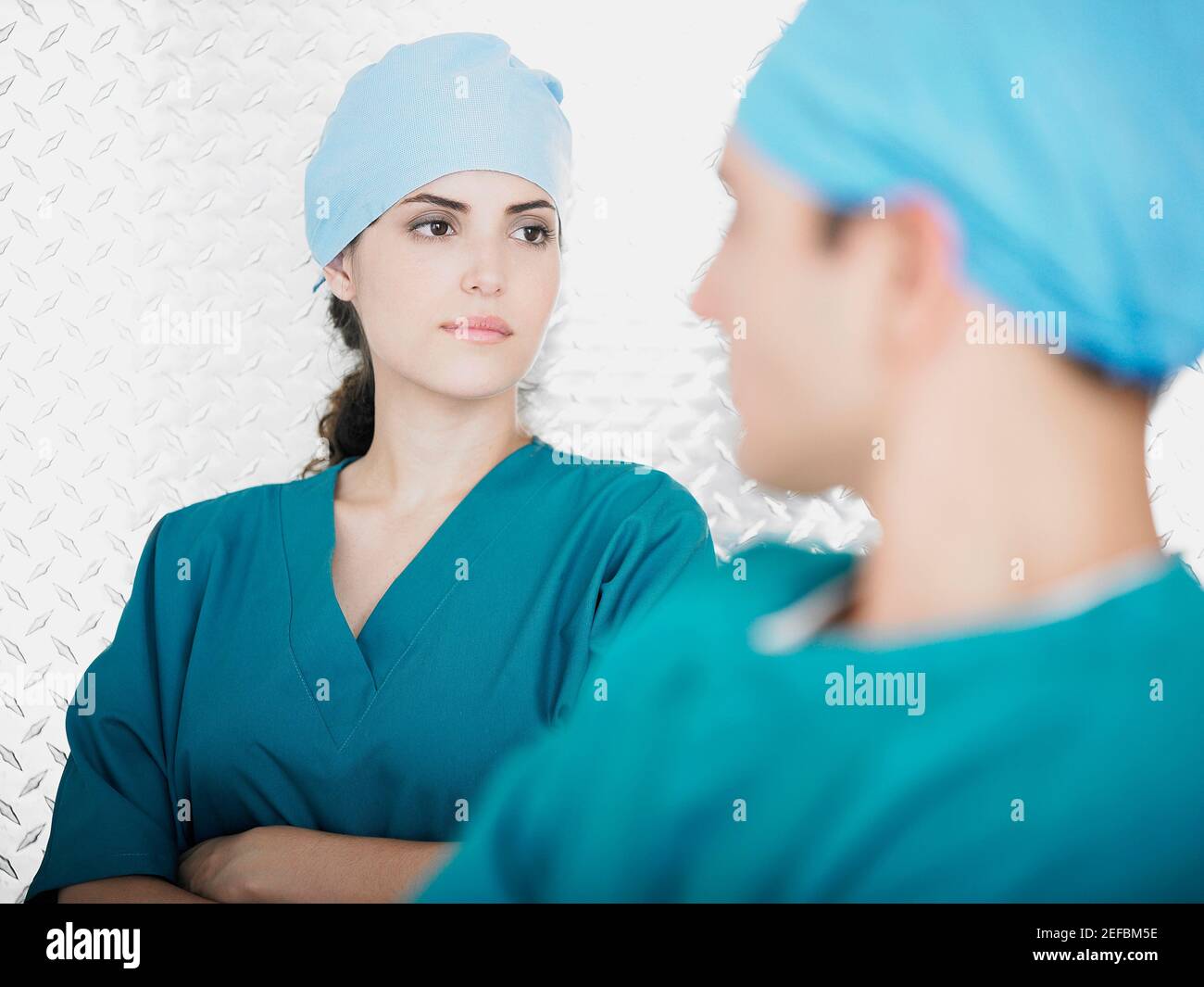 Close up of a female doctor behind a male doctor Stock Photo - Alamy