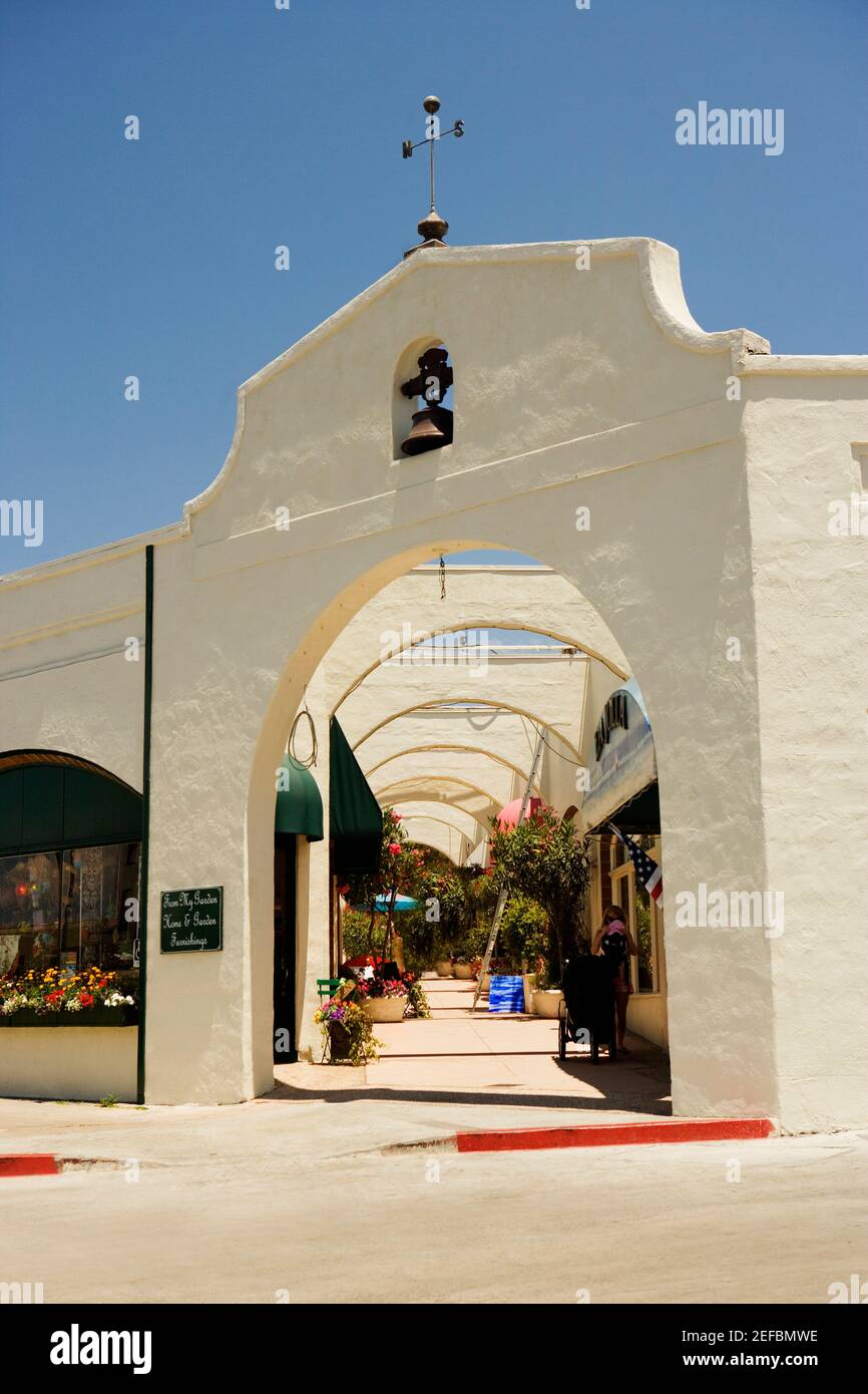 People walking under an arched walkway Stock Photo - Alamy