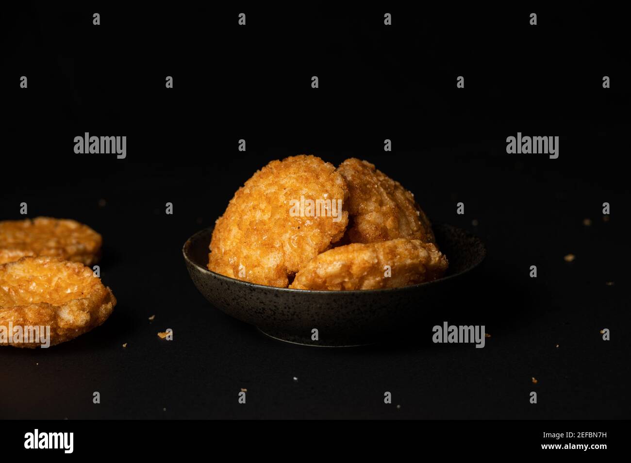 fried crispy rice crackers called rice age with soy,salt sugar etc ...