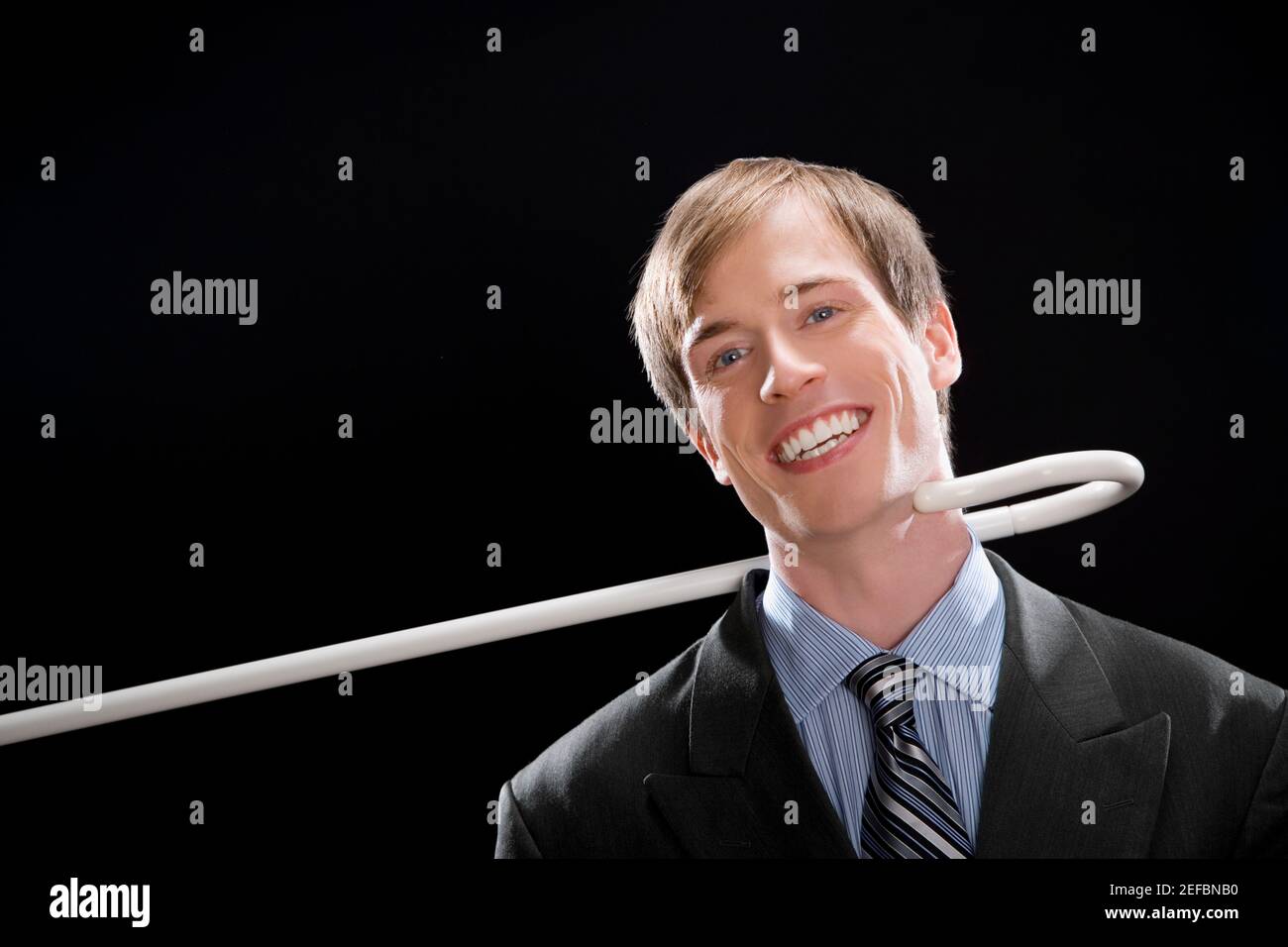 Portrait of a businessman smiling and being pulled by a cane Stock ...