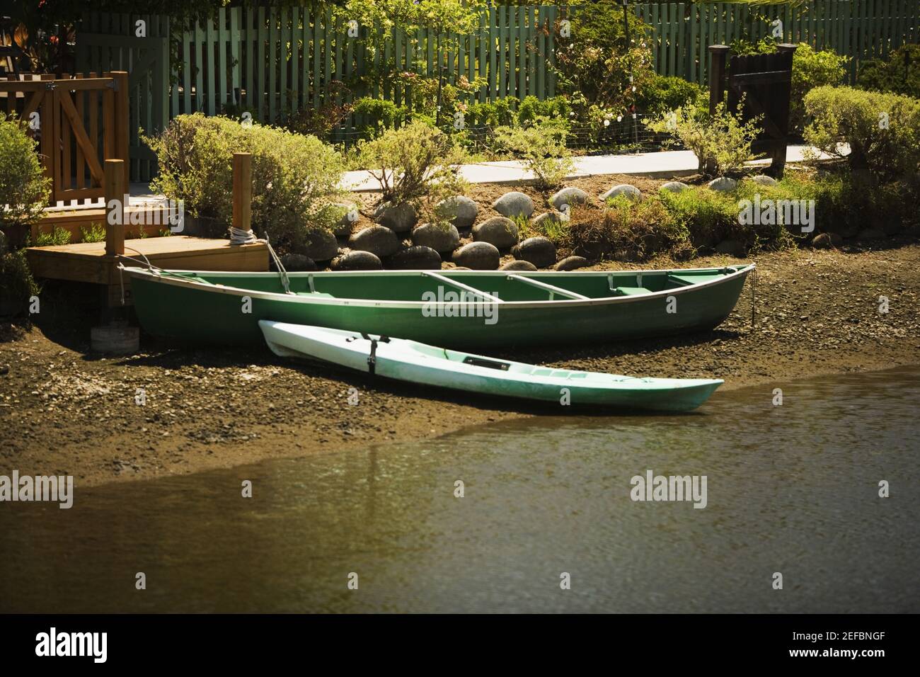 Side profile of a rowboat on a shore Stock Photo - Alamy
