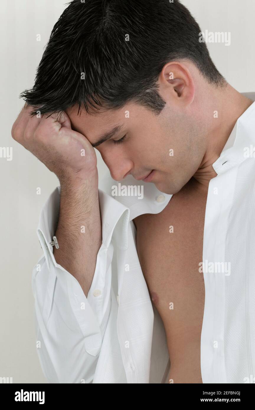 Close-up of a young man thinking with his hand on his forehead Stock ...