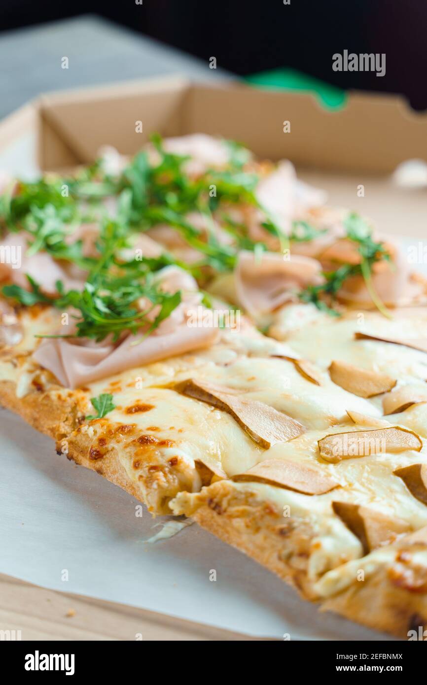 Pinsa romana with pear, cheese, prosciutto in delivery box ...