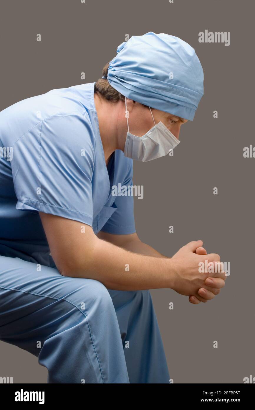 Side profile of a male surgeon thinking Stock Photo - Alamy