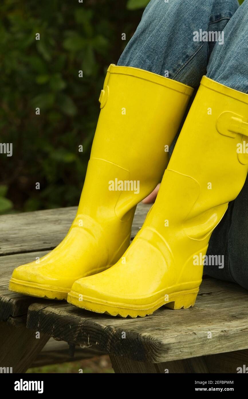 Low section view of a person wearing rubber boots Stock Photo - Alamy