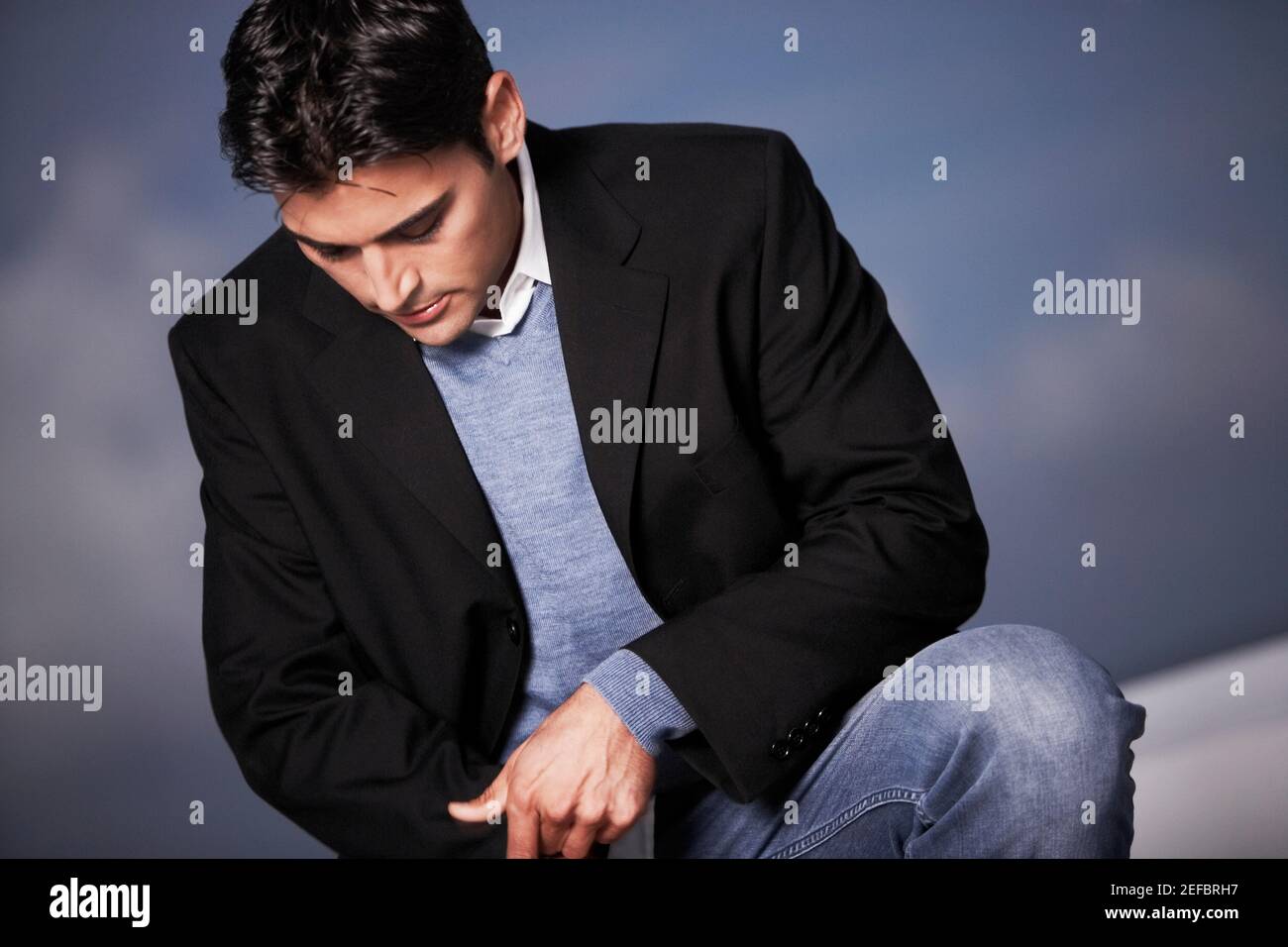 Close-up of a young man looking down Stock Photo - Alamy