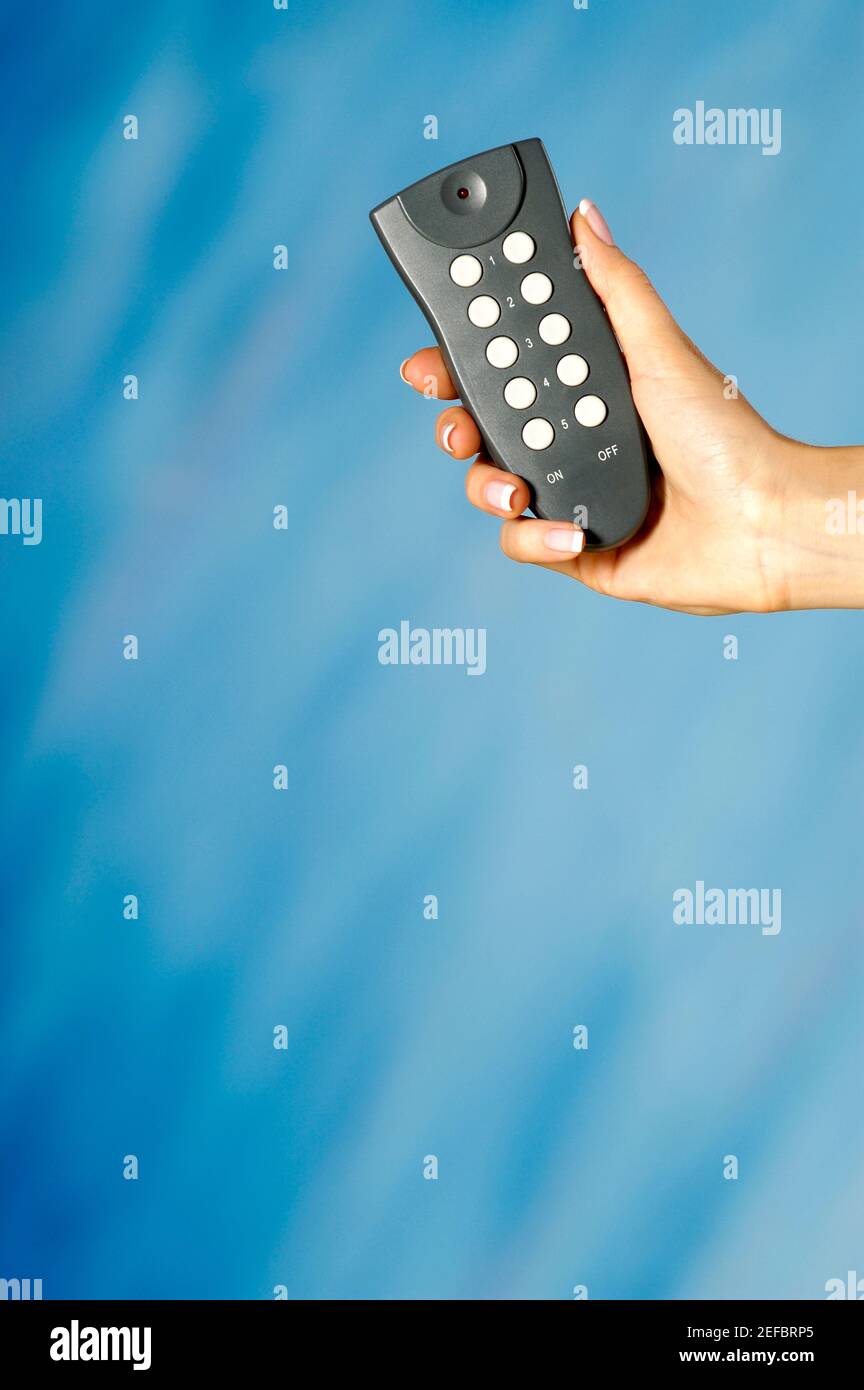 Woman pressing remote control hi-res stock photography and images - Alamy