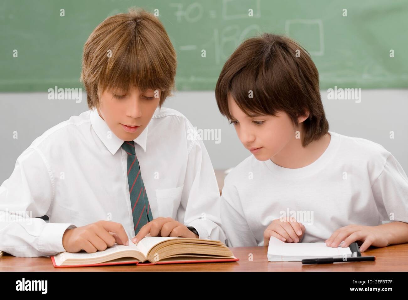 Two schoolboys studying in a classroom Stock Photo - Alamy