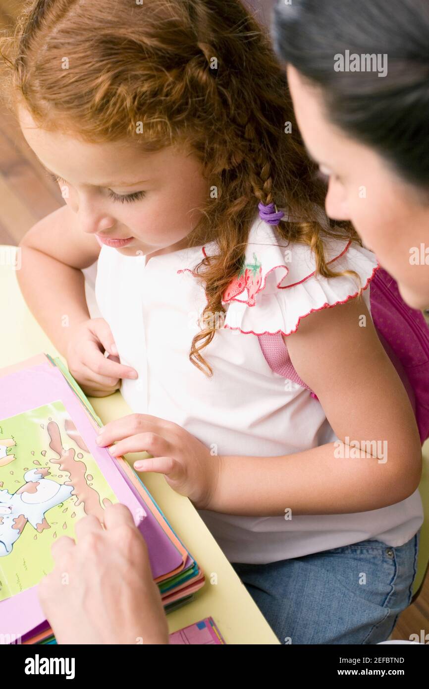 Female teacher teaching her student Stock Photo - Alamy