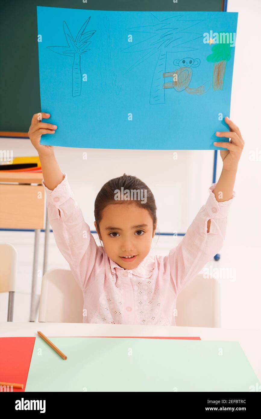 Portrait of a girl showing a drawing Stock Photo - Alamy