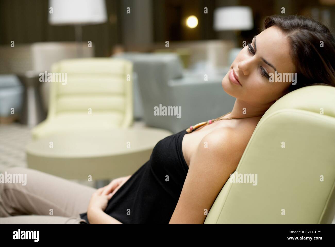Young woman sitting side profile chair hi-res stock photography and ...