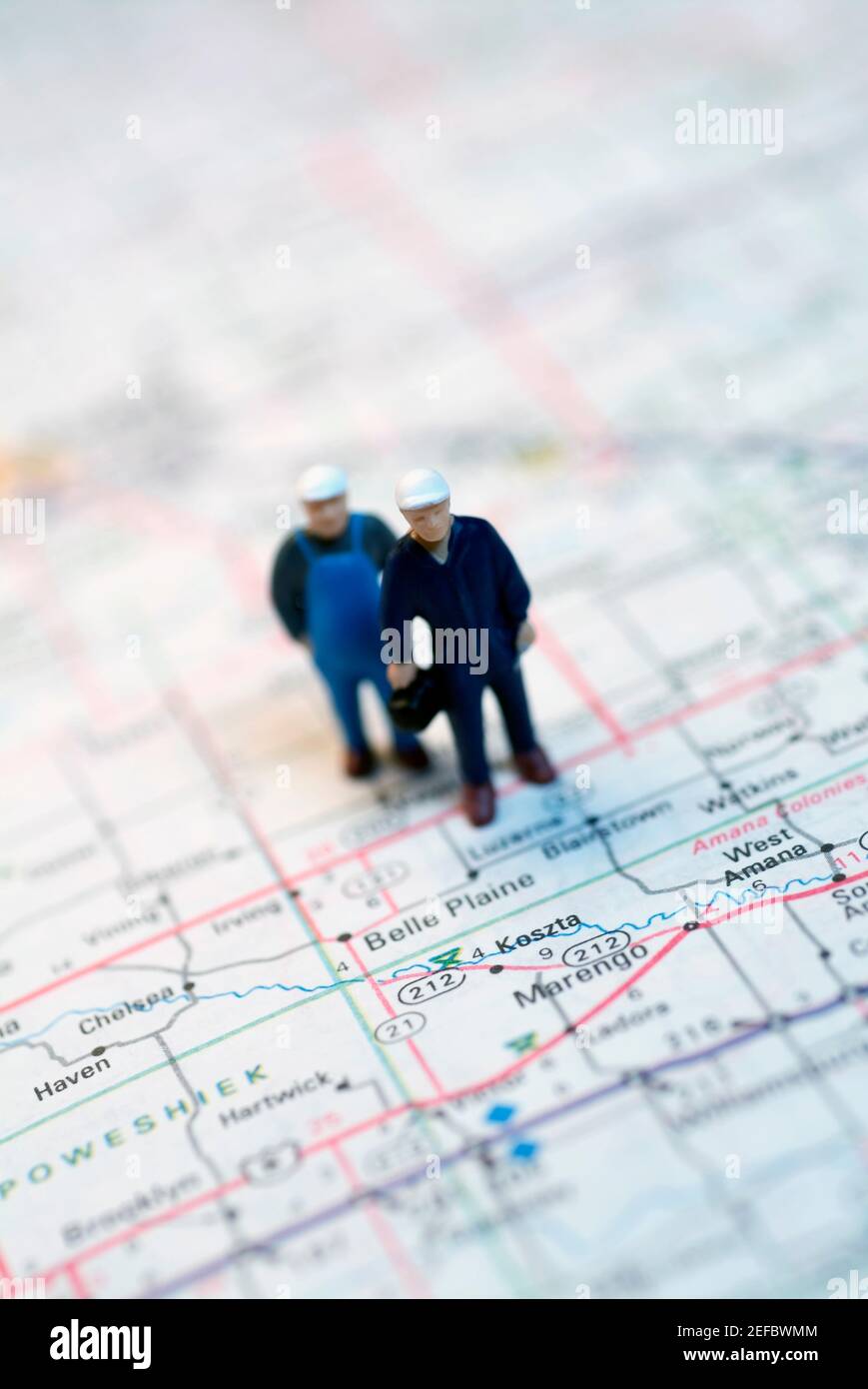 Close-up of the figurines of two construction workers on a map Stock ...