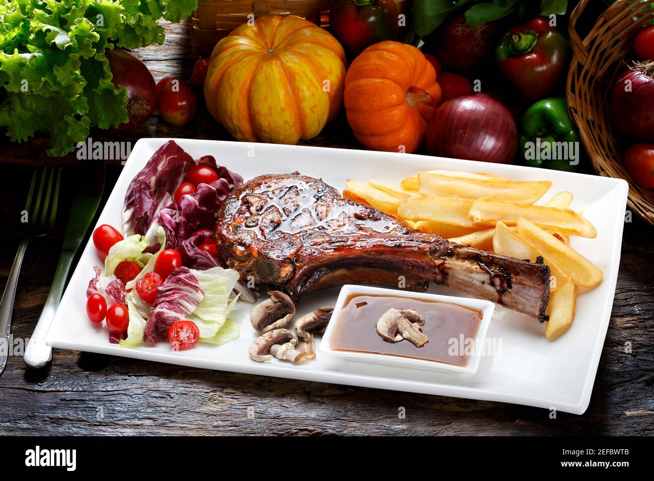 Prime rib with fries and salad Stock Photo - Alamy
