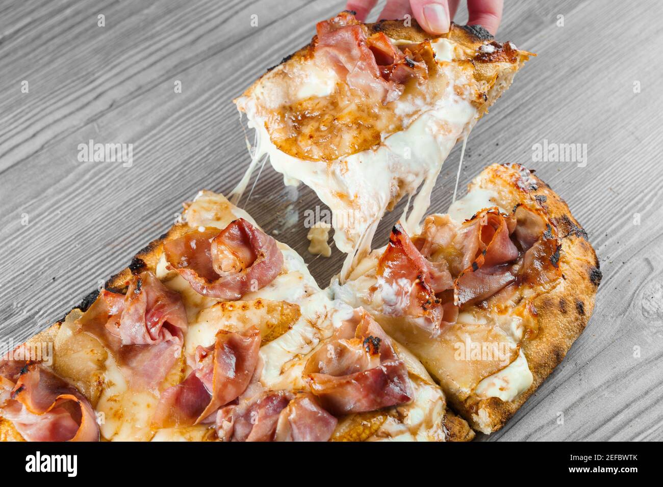 Mozzarella stretching cheese on pinsa romana gourmet italian cuisine ...