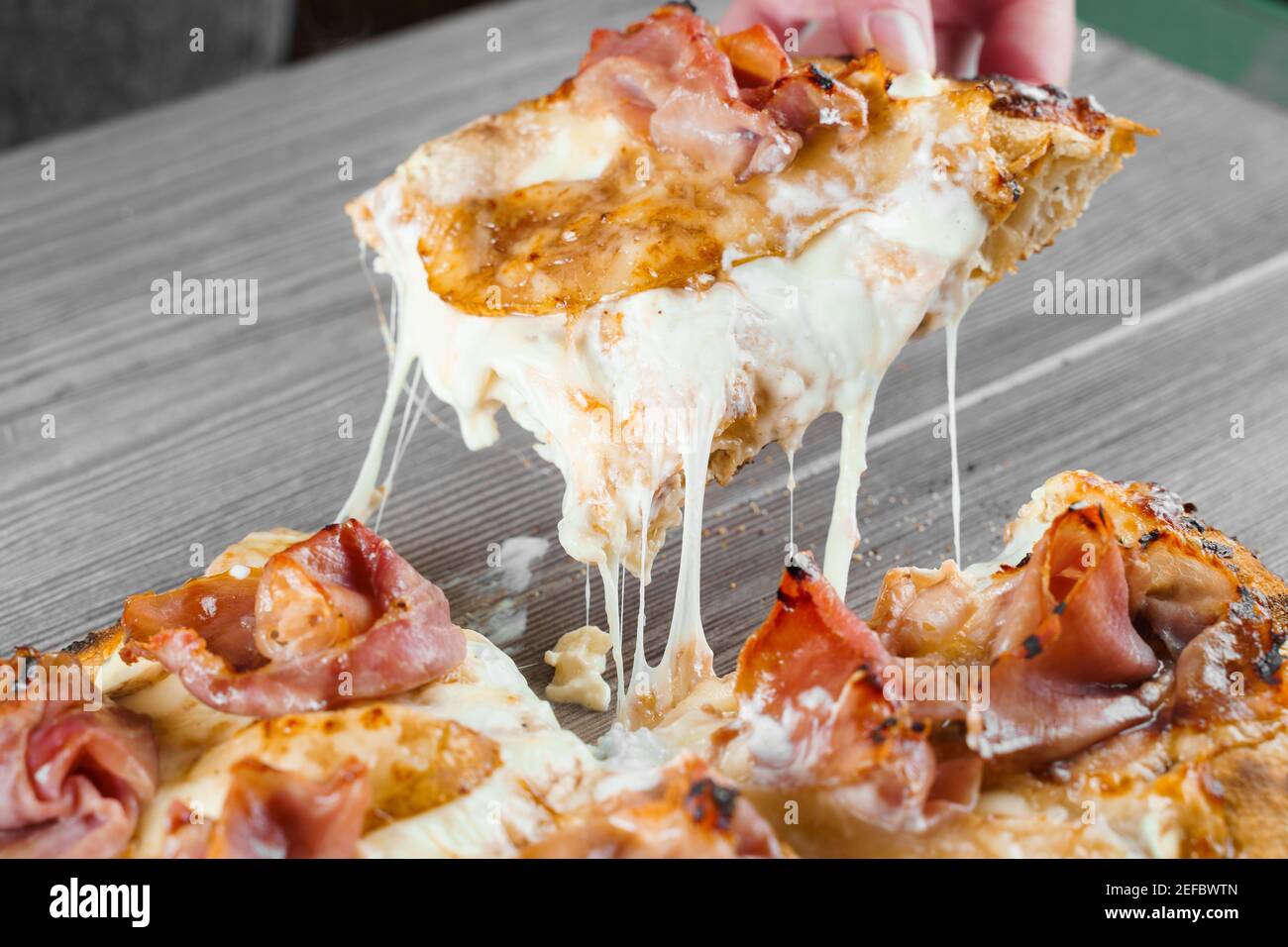 Mozzarella stretching cheese on pinsa romana gourmet italian cuisine ...