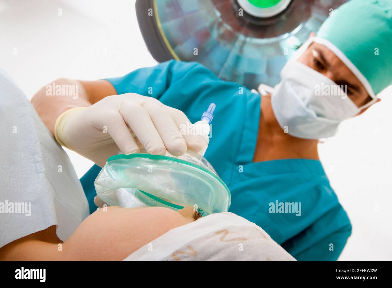 Doctor putting oxygen mask on hi-res stock photography and images - Alamy