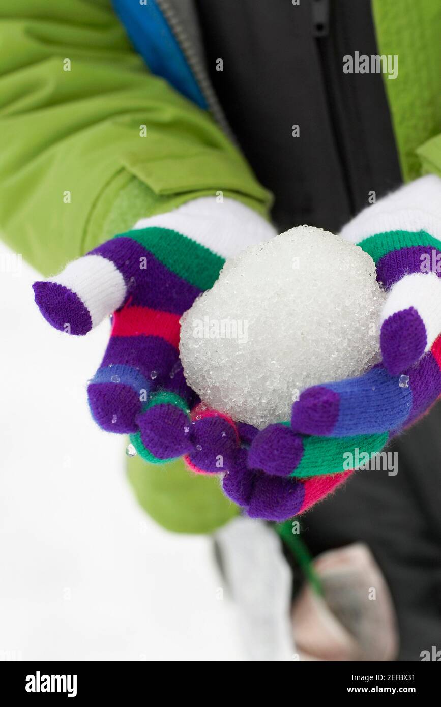 Mid section view of a person holding a snowball Stock Photo - Alamy