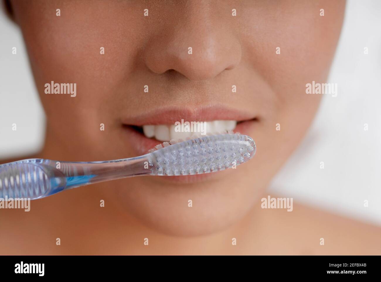 Close-up of a young woman brushing her teeth Stock Photo - Alamy