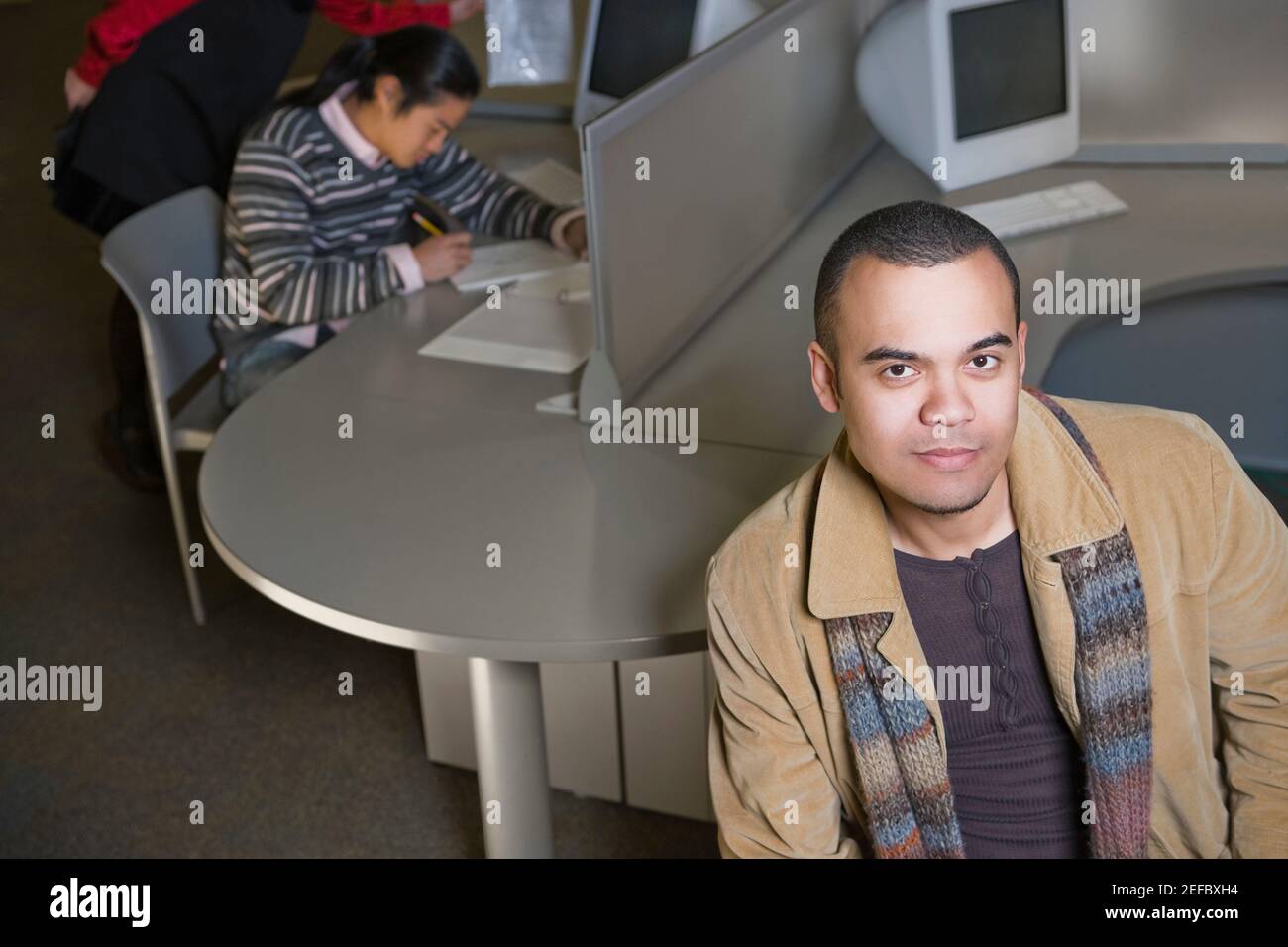 Portrait of a young man with another young man sitting behind him Stock ...