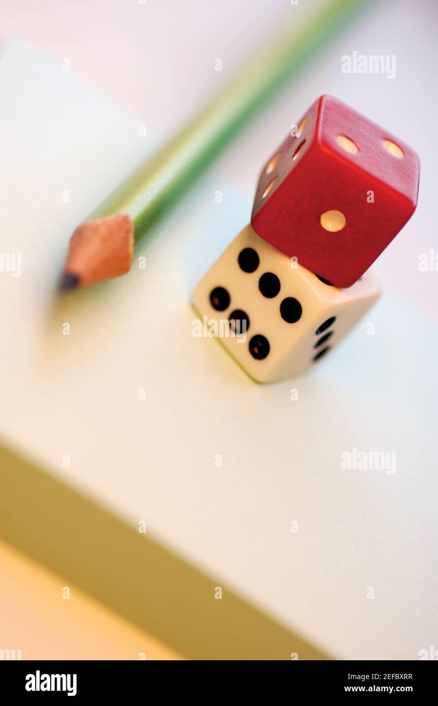 Close-up of two dices with a pencil Stock Photo - Alamy