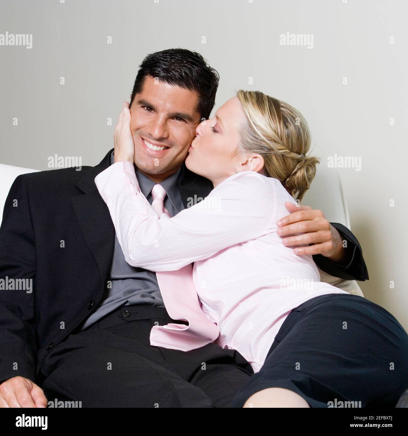 Businesswoman kissing a businessman Stock Photo - Alamy