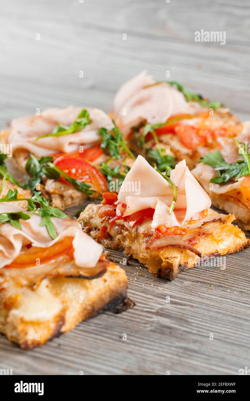 Pinsa romana cut into pieces portions for one person. Food delivery ...