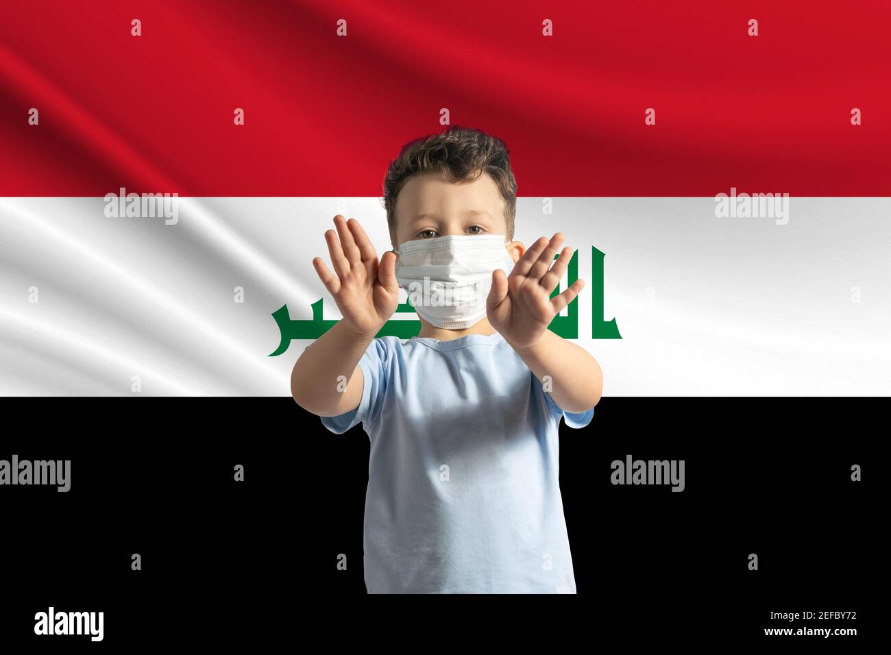 Little white boy in a protective mask on the background of the flag of ...