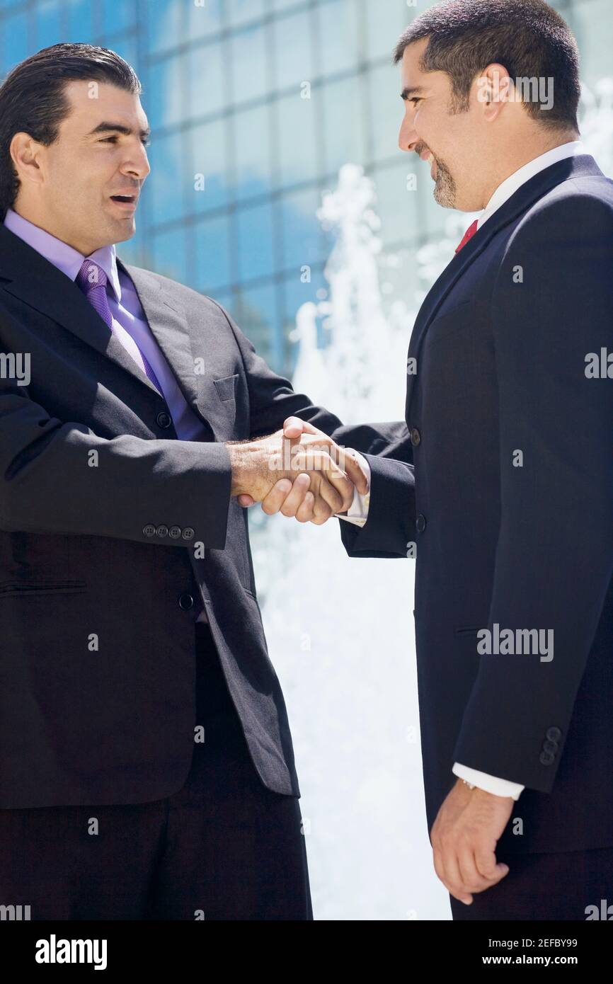Side view businessman black suit handshake hi-res stock photography and ...