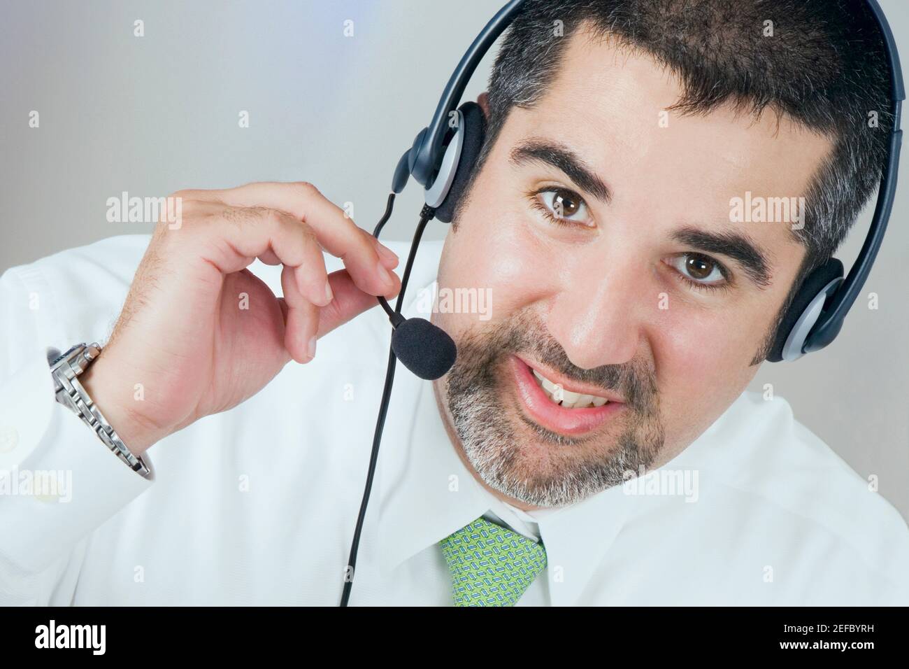 Close-up of a male customer service representative wearing a headset ...
