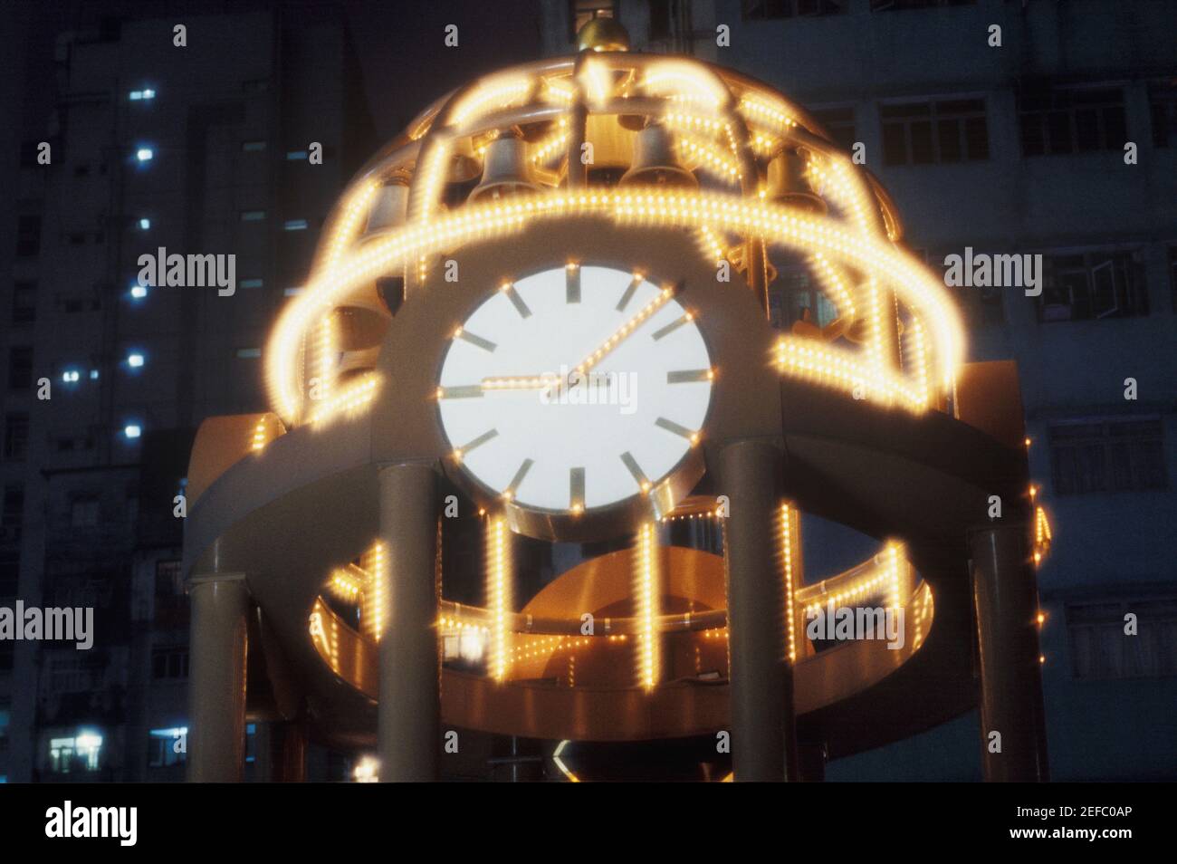 High section view of a clock tower lit up at night, Hong Kong, China ...