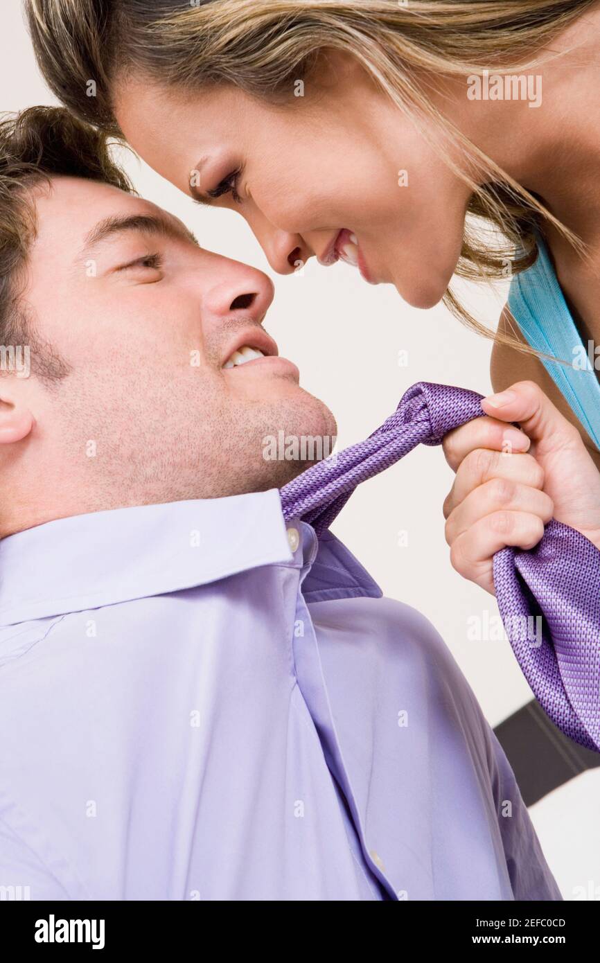 Woman pulling tie hi-res stock photography and images - Alamy