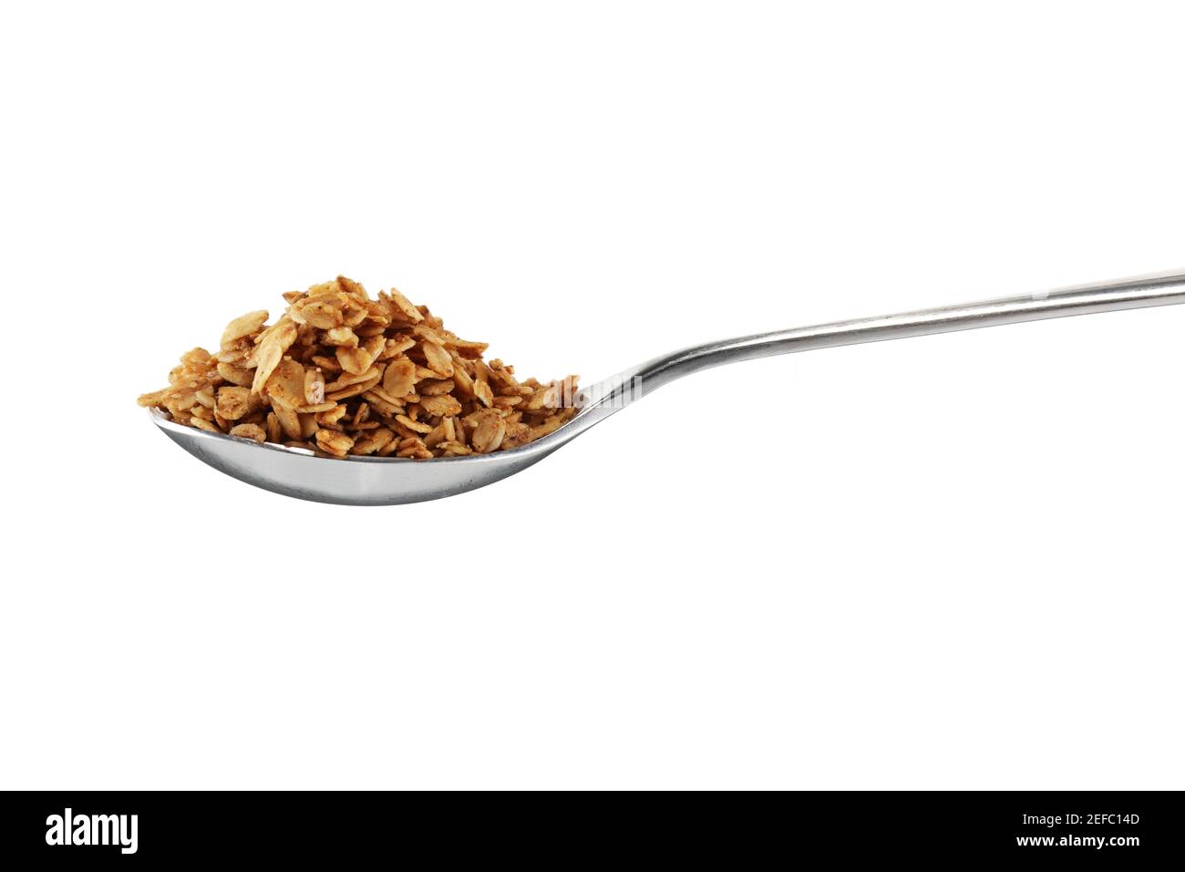 Granola on a silver spoon side view on white background Stock Photo - Alamy