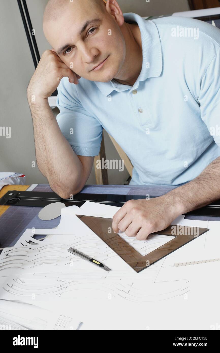 Portrait of a male architect leaning on an elbow Stock Photo - Alamy