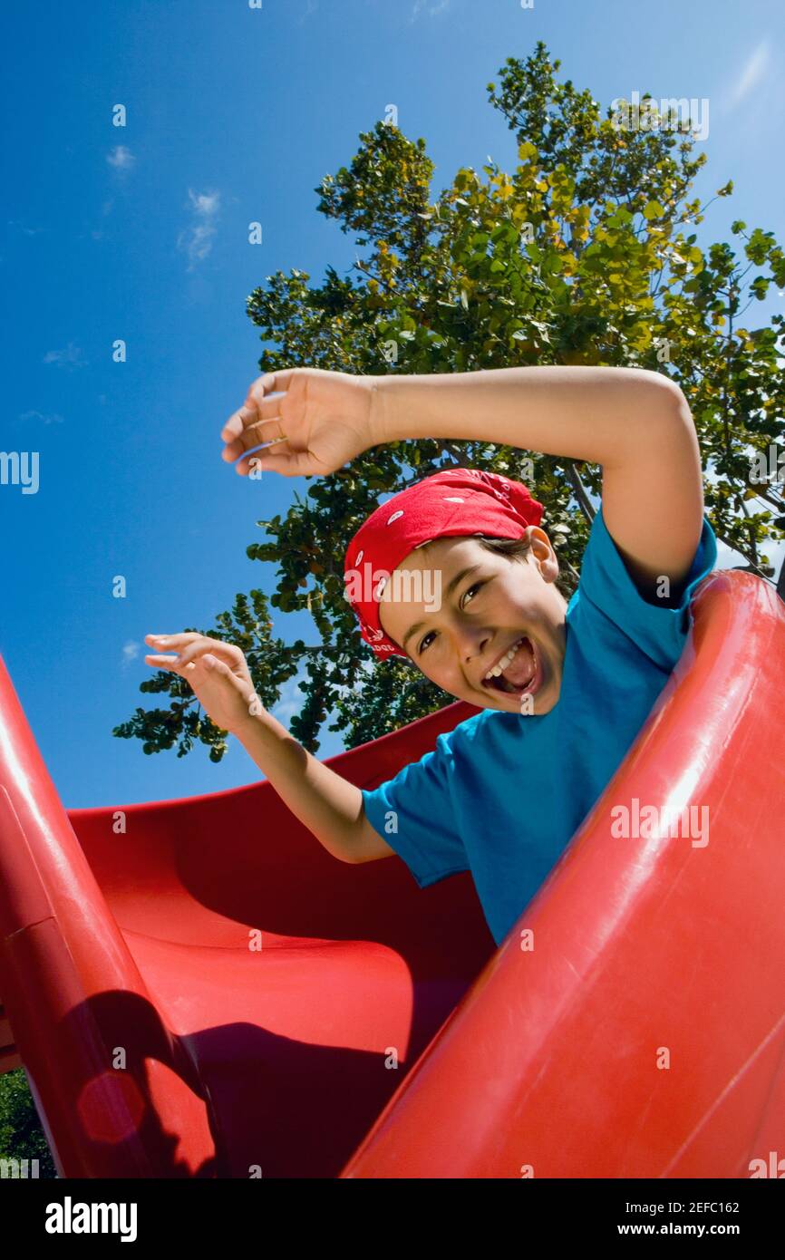 Portrait of a boy sliding on a slide Stock Photo - Alamy