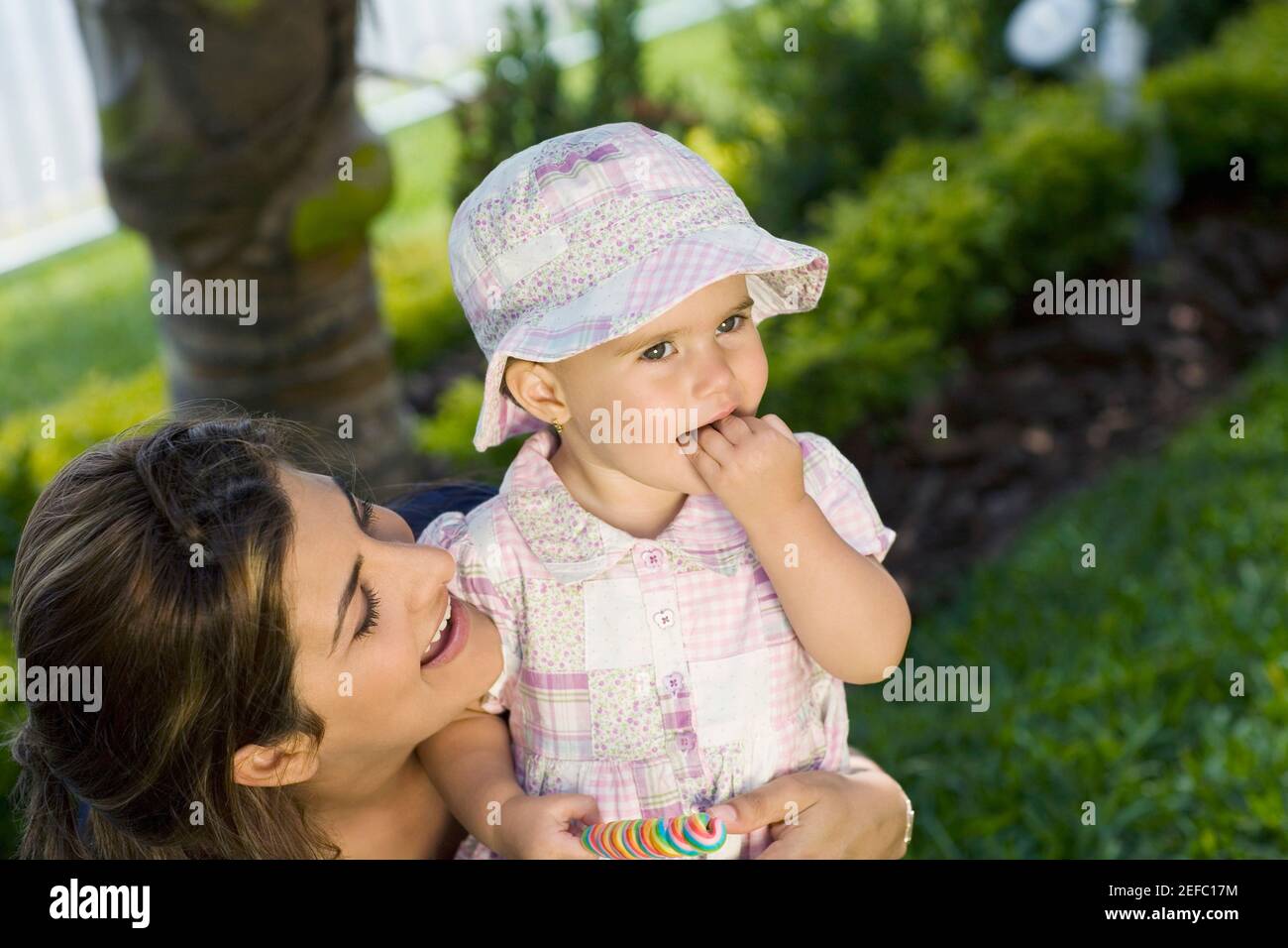 Girl smiling with her mother Stock Photo - Alamy
