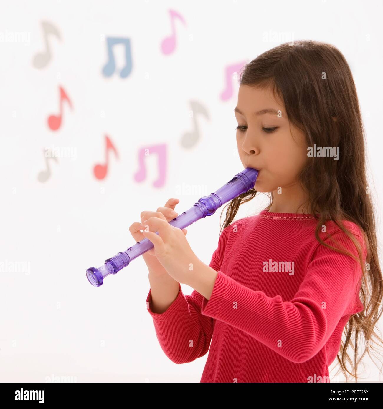Side profile of a schoolgirl playing a flute in a classroom Stock Photo ...