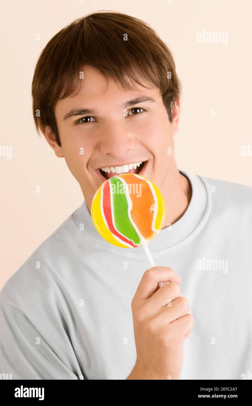 Young man holding lollipop hi-res stock photography and images - Alamy