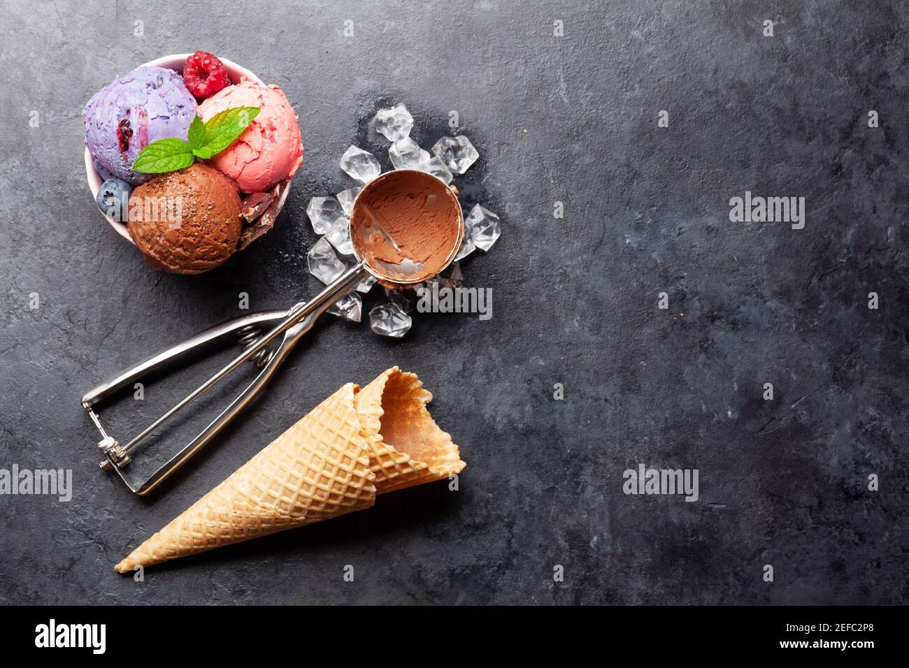 Berry, vanilla and chocolate ice cream sundae. Top view flat lay with ...