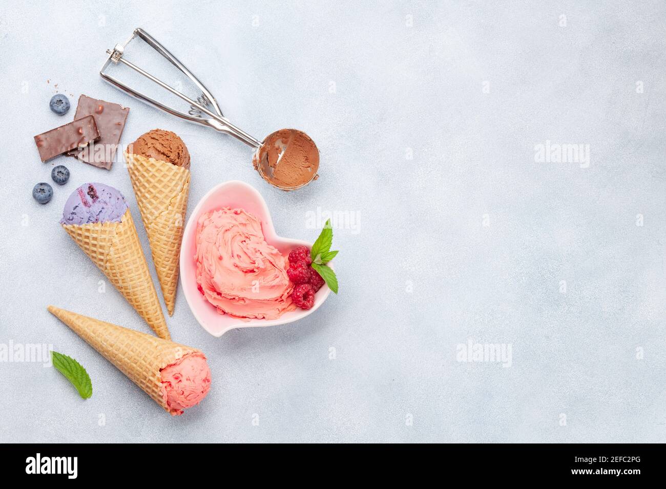 Berry, vanilla and chocolate ice cream sundae. Top view flat lay with ...